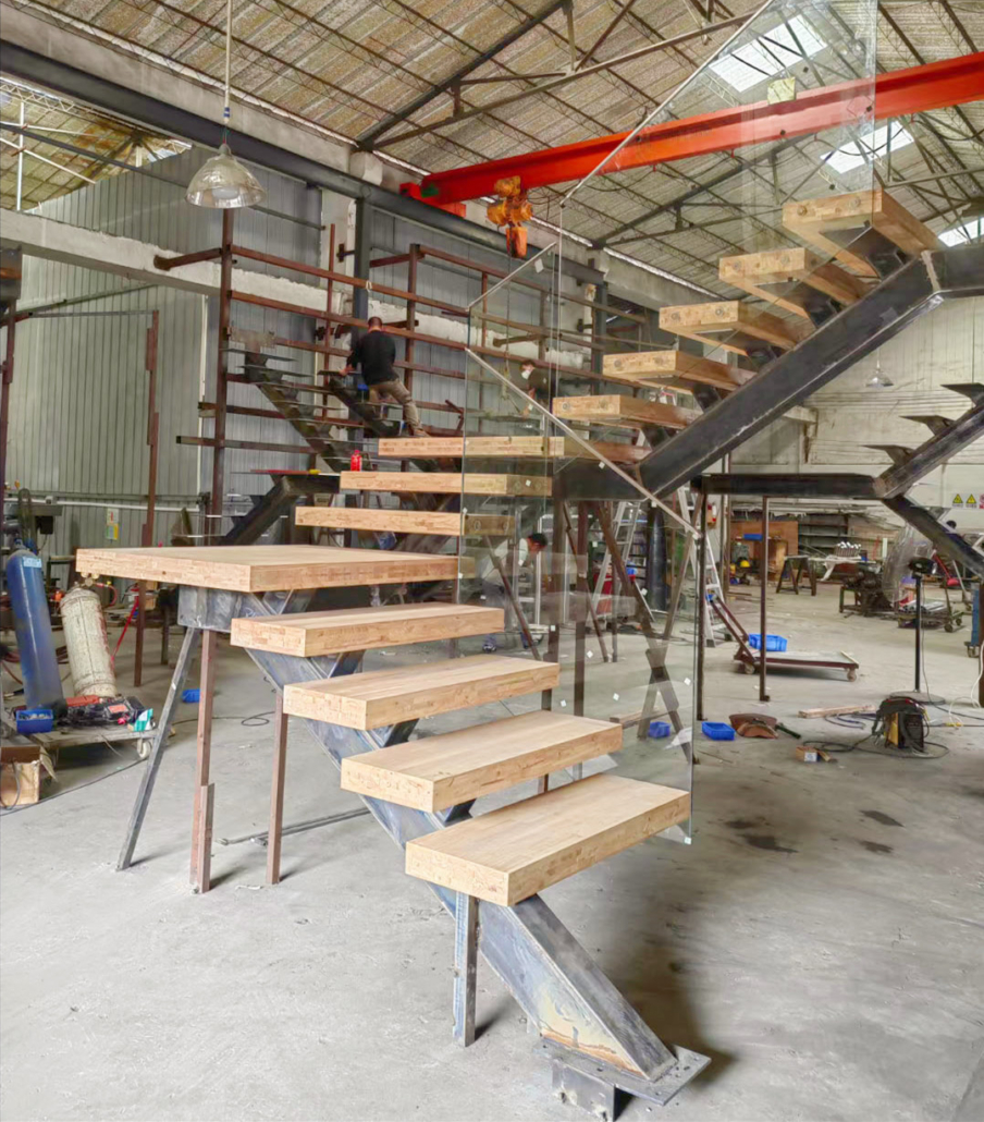 Mono stringer staircase with glass railing wooden treads