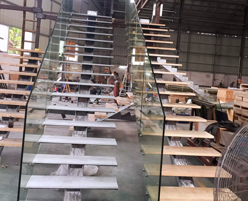 Mono stringer staircase with glass railing wooden treads